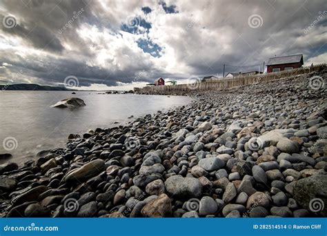 Long Exposure Shoreline Overlooking Rustic Boat House With Atlantic Cod