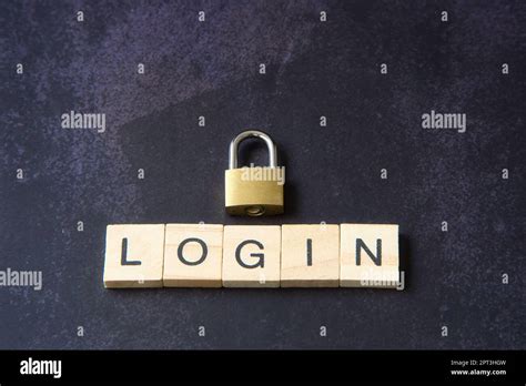 Word Login Written In Wooden Letters Next To A Padlock Representing