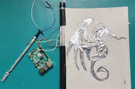 Image Showing A Raspberry Pi Connected To A Home Made Book With A Shiny Dragon Cut Out Of The Cover
