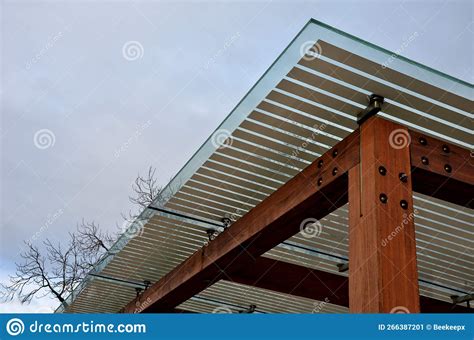 Terrace With Wooden Pergola And Plexiglass Roof Vines Are Straining