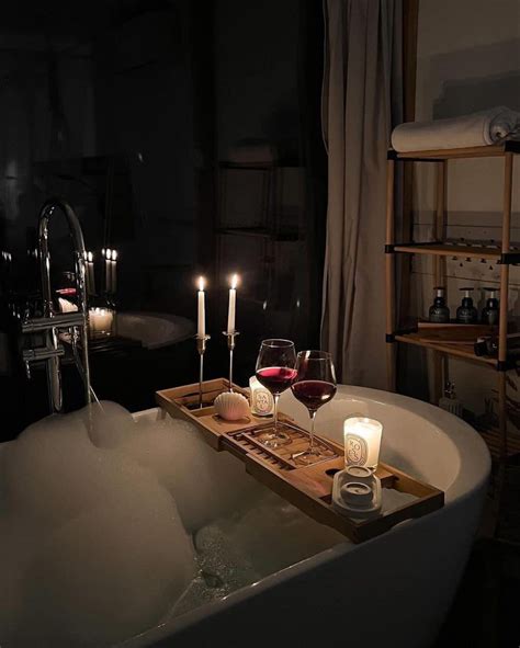 Romantic Spa Ambiance With Candlelit Bath And Wine Glasses