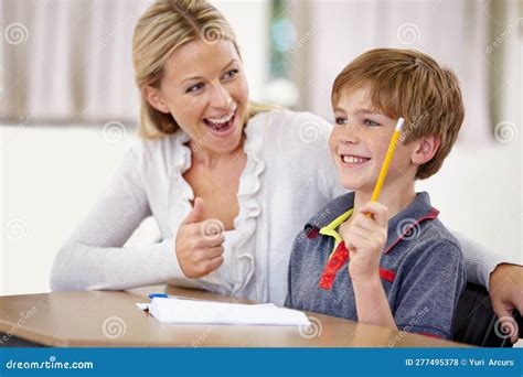Thumbs Up Happy Teacher With Student In Classroom In School And