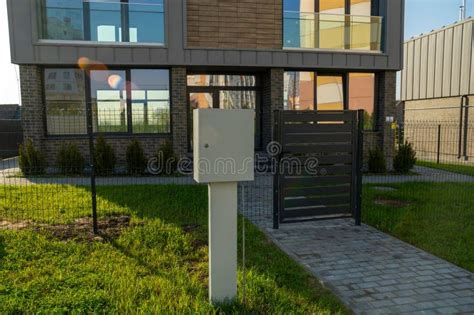 Electrical Panel With Meter Installed On Exterior Wall Of Modern Two Story Townhouse Stock Image