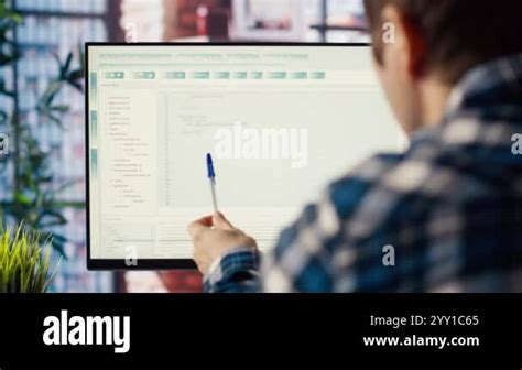 programmer at desk typing code developing software programs entering