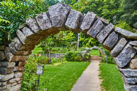 Premium Photo Rustic Stone Archway In Lush Garden Path Perspective