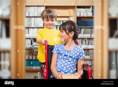 Composite Image Of Cute Pupils At The Library Stock Photo Alamy