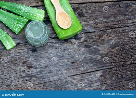 Fresh Aloe Vera Stem Slices And Gel On Wooden Table Skin Therapy