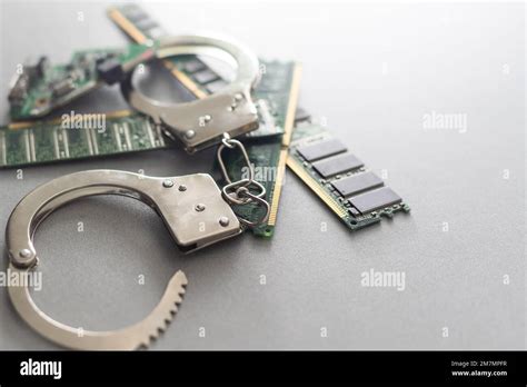 Handcuffs Against A Computer Electronics Board The Concept Of