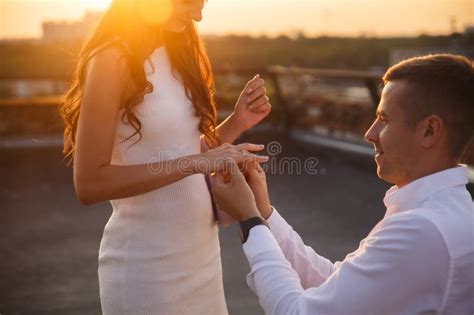 Couple Engages In A Romantic Sunset Proposal On A Rooftop In The City