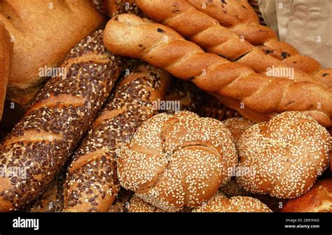 Close Up Several Assorted Fresh Wheat Bread Buns Loaves And Baguettes