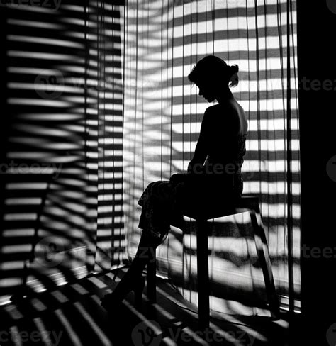 Woman Sitting Against Wall