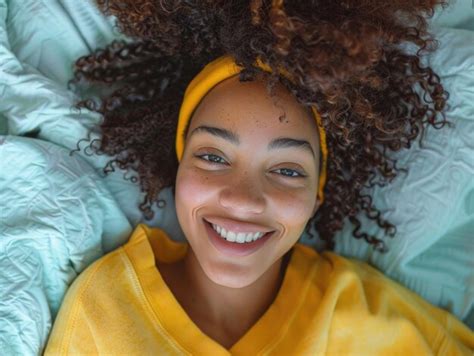 Premium Photo A Curly Haired Girl Lying In Bed Looking At The Camera