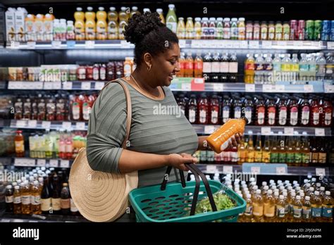 Side View Portrait Of Smiling Black Woman Grocery Shopping In
