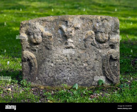 An Old Weathered Gravestone On Which The Original Inscription Has Long