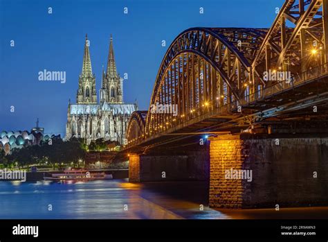 Cologne Cathedral And The Hohenzollern Bridge Over The Rhine After