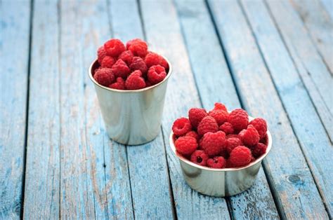Premium Photo White Can And Mug With Fresh Raspberry