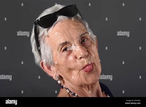 Portrait Of Senior Woman Sticking Tongue Out Stock Photo Alamy