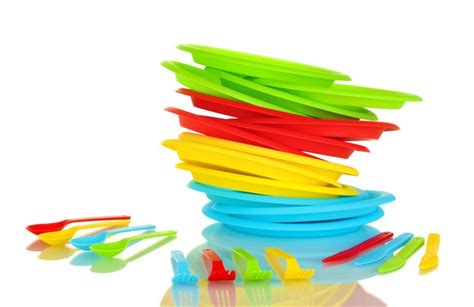 Premium Photo Bright Plastic Disposable Tableware Isolated On White