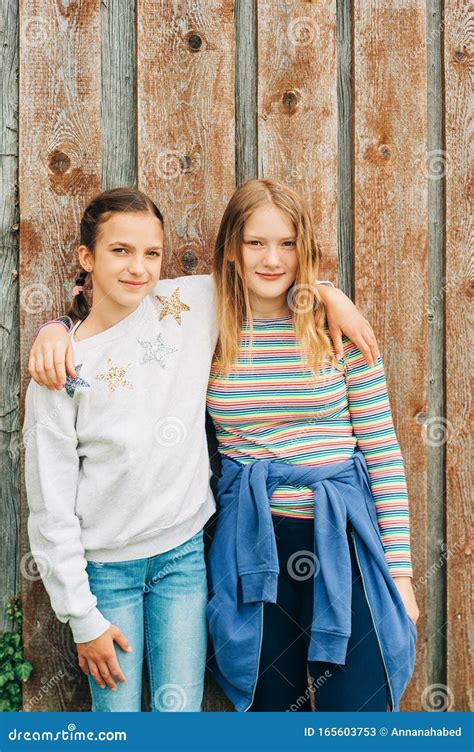 Young Preteen Girl Stretching Bunch Of Tulips To The Camera Sunset