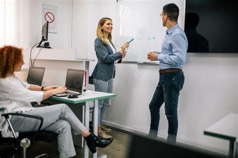 Teachers Teaching Young Students A Programming Class In The Classroom