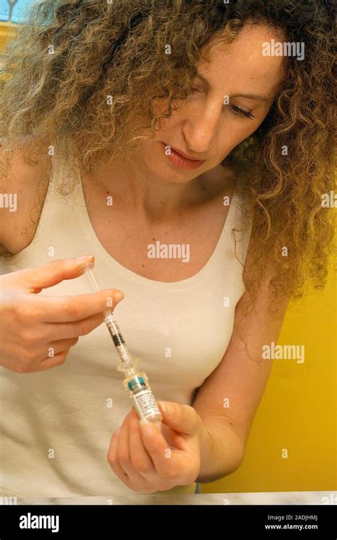 Multiple Sclerosis Treatment Woman Using A Syringe To Draw Beta