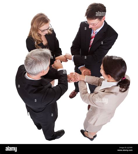 Group Of Four Diverse Businesspeople Standing In A Circle Facing Each