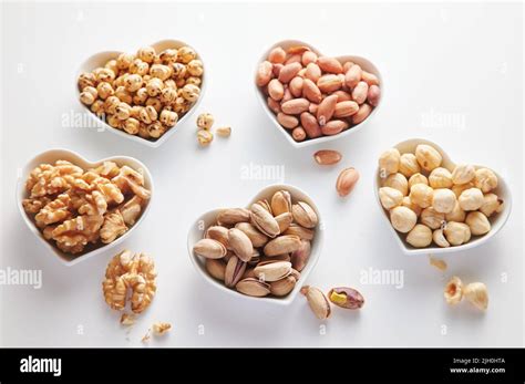 From Above Of Assorted Types Of Healthy Nuts Served On Ceramic Heart