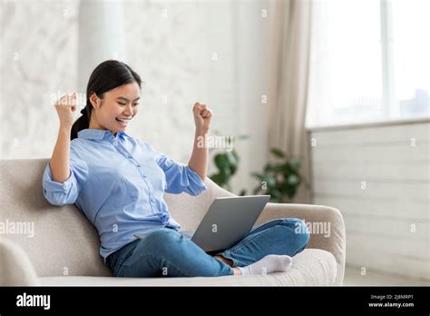 Cute Asian Lady With Laptop Celebrating Success Home Interior Stock