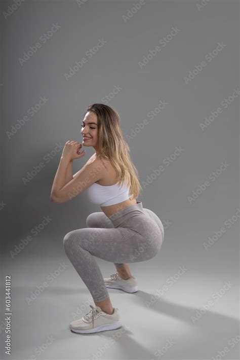 Squat Exercises Attractive Young Fitness Girl Doing Squat Exercises In