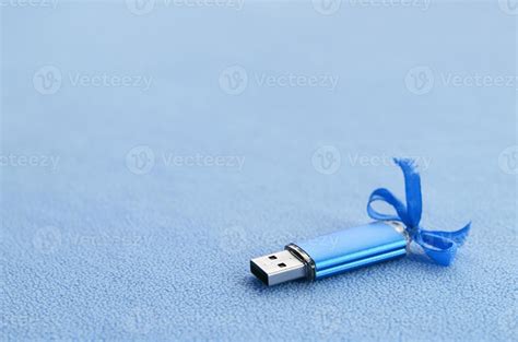Brilliant Blue Usb Flash Memory Card With A Blue Bow Lies On A Blanket Of Soft And Furry Light