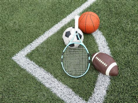 Assorted Sports Equipment Including A Basketball Soccer Ball Tennis