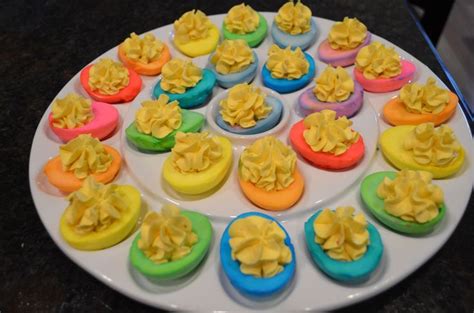 There Are Many Small Cupcakes On The Plate With Yellow Frosting In Them