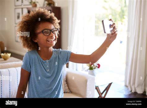 Pre Teen Girl Taking A Selfie Photo Standing In The Living Room