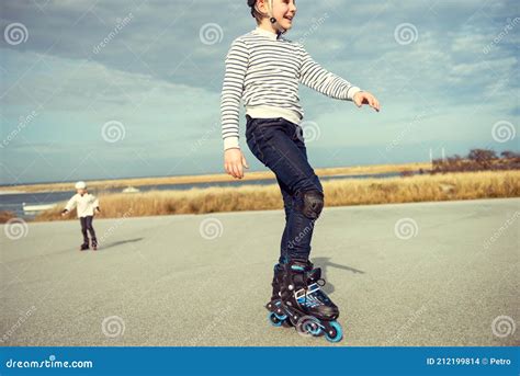 Happy Siblings Teenager Boy And Girl Having Fun During Inline Skating