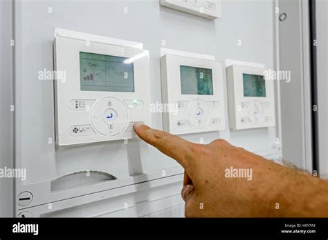 hand is pushing button operating to climate control panel which