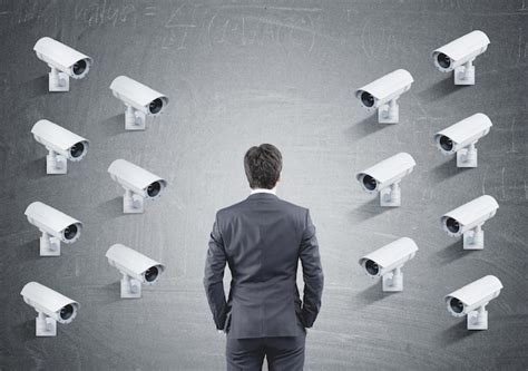 Premium Photo Many Cctv Cameras On One Wall Rear View Of A Man