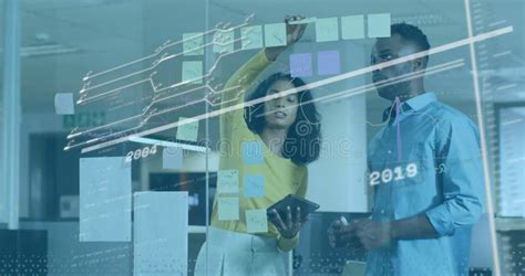 Analyzing Data With Digital Graphs And Sticky Notes Business Professionals In Office Stock