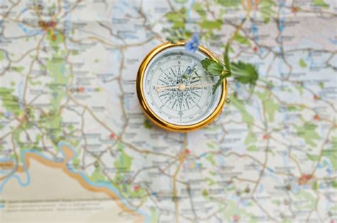Close Up Photo Of Compass Laying On The Map Premium Photo