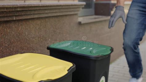 Close View Of The Sorting Bin And The Male Hands In Gloves Puts Two