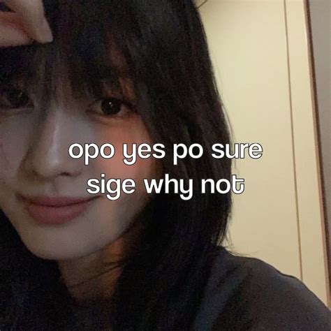 A Woman With Long Black Hair Is Holding Her Hand Up To Her Face And The
