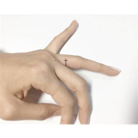 Tiny Cross Tattoo Done On The Finger Minimalistic