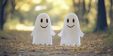 Two Cute White Ghosts With Smiley Faces Wearing Simple Ghost Costumes