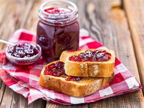 A Jar Of Jam With Jam And Bread On It Premium Ai Generated Image