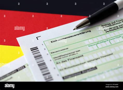 German Annual Income Tax Return Declaration Form With Pen On Flag Close