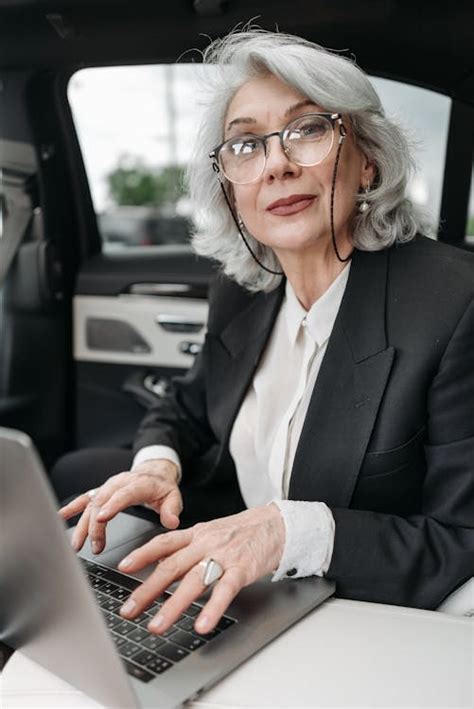 Woman In Black Blazer Wearing Eyeglasses Using A Laptop Computer · Free