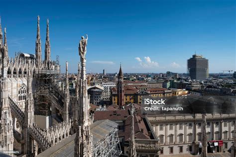Rooftop Of Duomo Di Milano Or Milan Cathedral With Spires And Statues