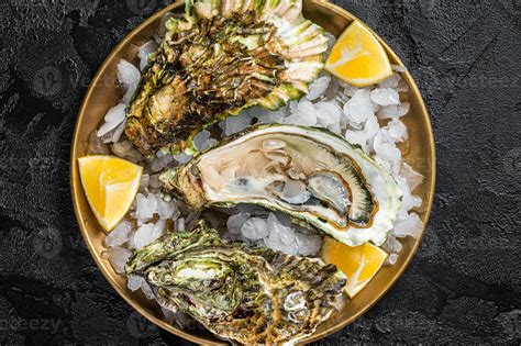Fresh Oysters With Lemon On Ice Dark Background Top View 53512065