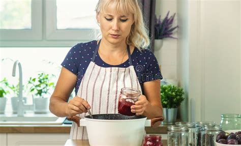Raspberry Jam In The Hands Of A Woman Selective Focus Stock Image