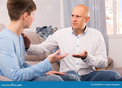 Father Talking To A Man And Boy