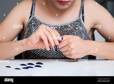 Young Unrecognizable Gender Fluid Person Removing False Nails Stock